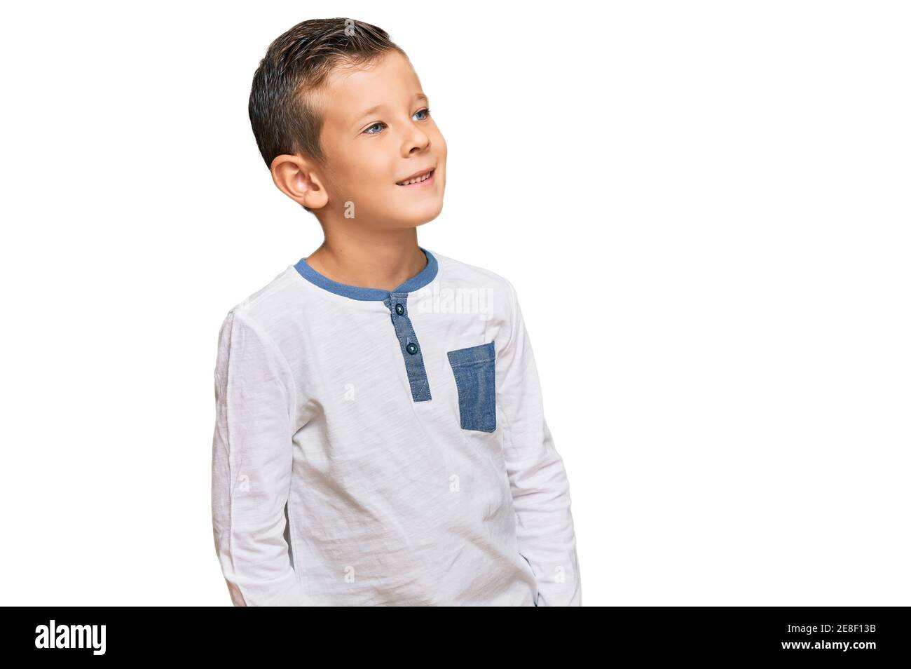 Adorable caucasian kid wearing casual clothes looking away to side with ...