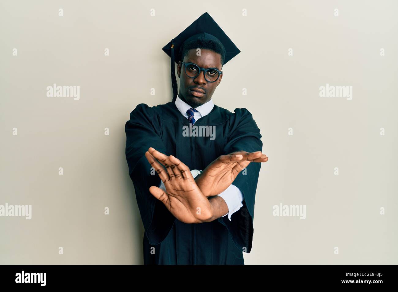 Handsome black man wearing graduation cap and ceremony robe rejection ...