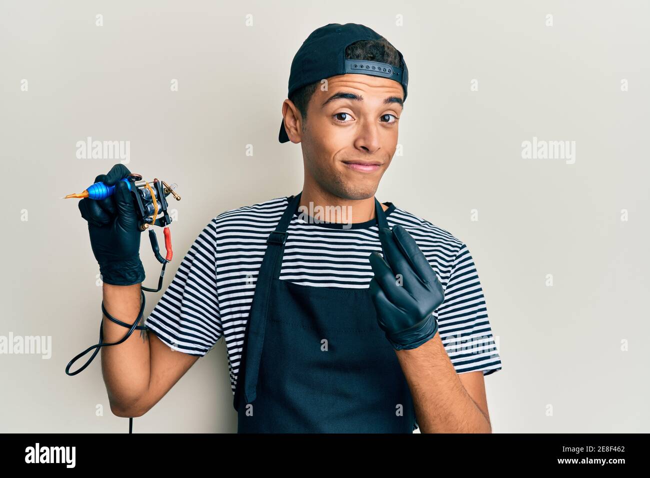 Young handsome african american man tattoo artist wearing professional ...