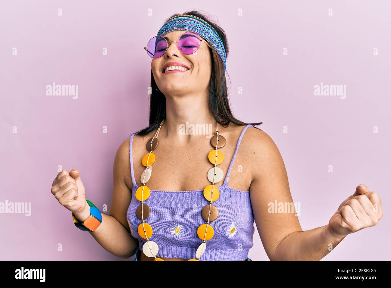 Young brunette woman wearing bohemian and hippie style very happy and ...