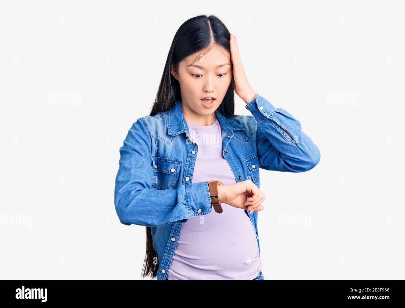 Young beautiful chinese woman pregnant expecting baby looking at the ...