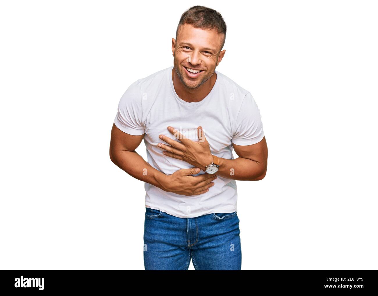 Handsome muscle man wearing casual white tshirt smiling and laughing ...