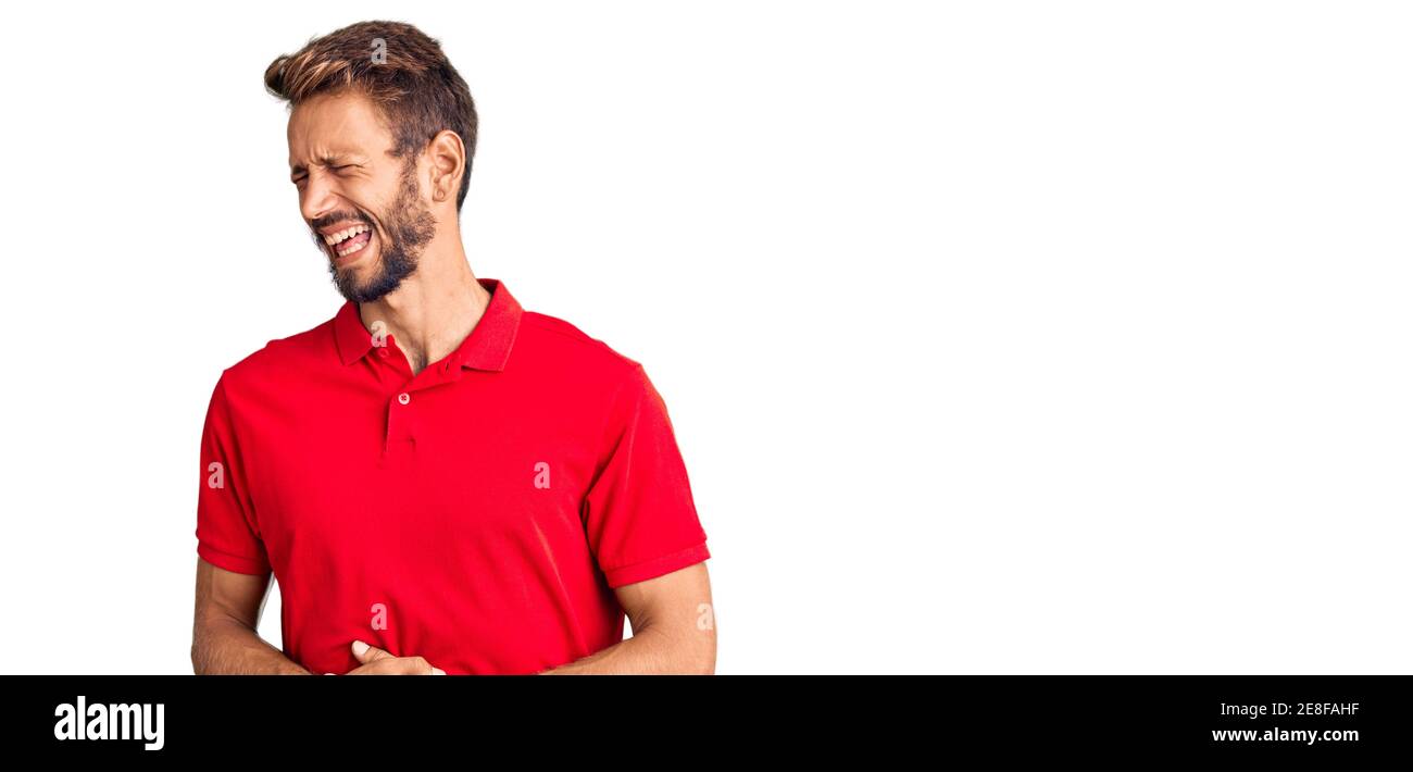 Handsome blond man with beard wearing casual clothes with hand on ...