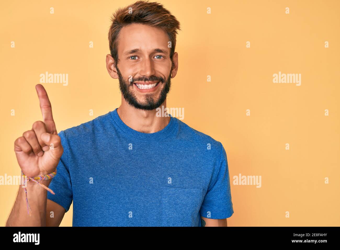 Handsome caucasian man with beard wearing casual clothes showing and ...