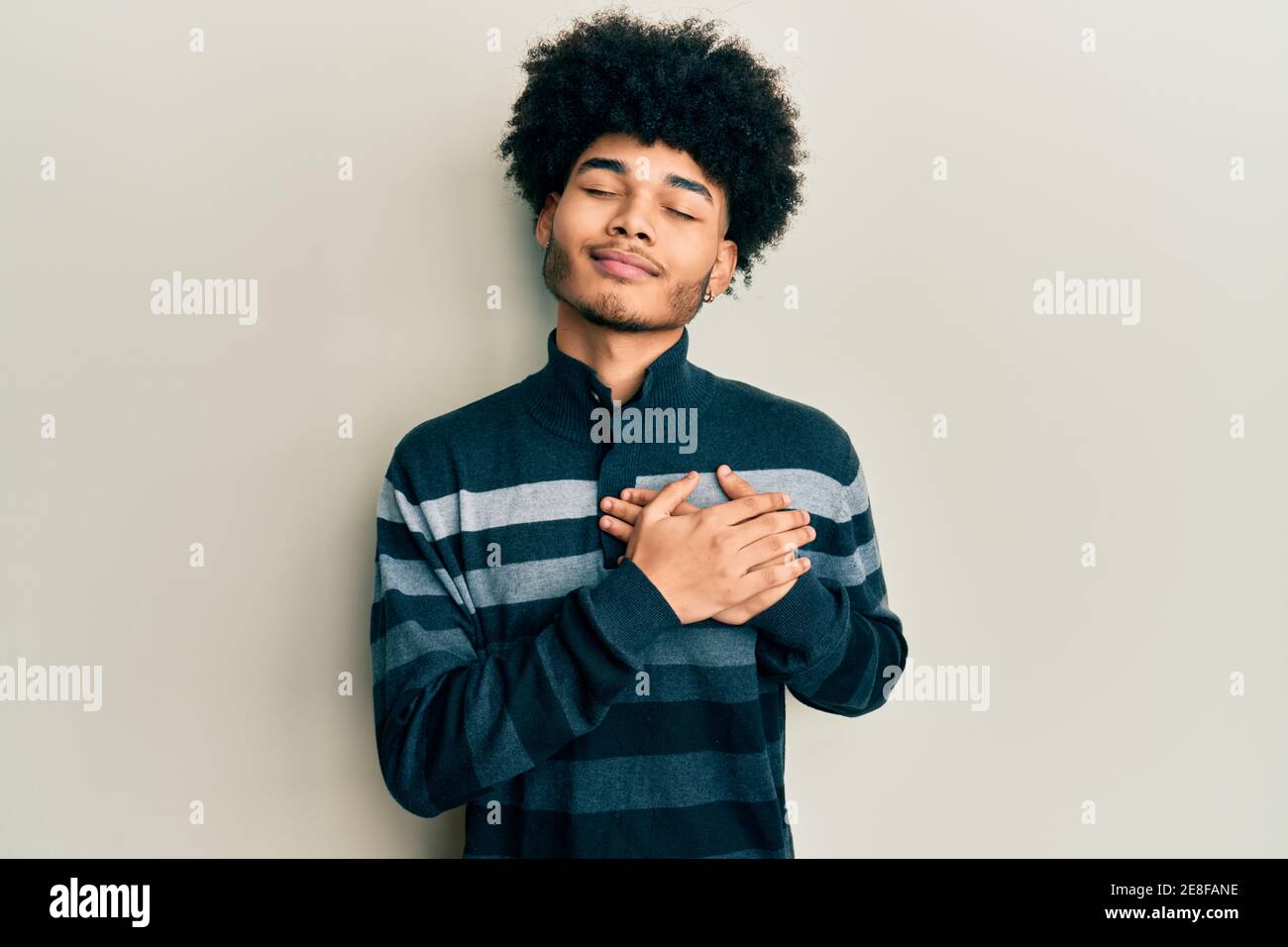 Young african american man with afro hair wearing casual clothes ...