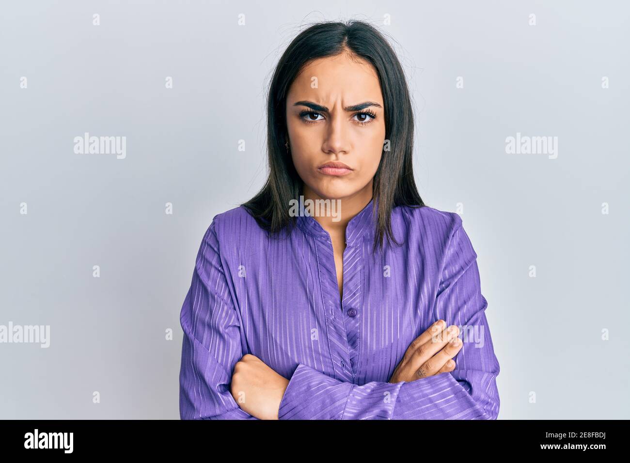 Young brunette woman wearing casual clothes skeptic and nervous ...