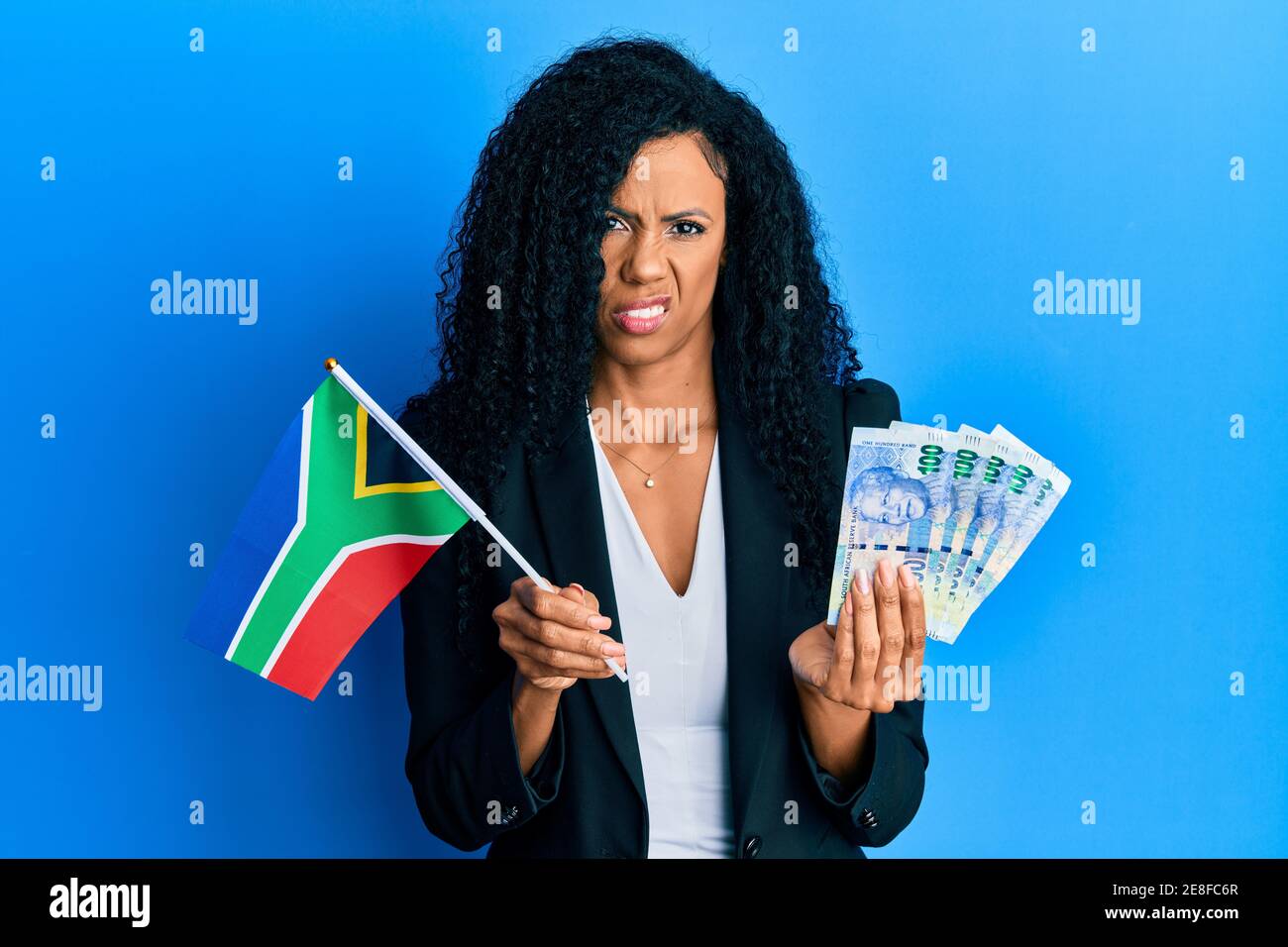 Middle age african american woman holding south african flag and rands ...