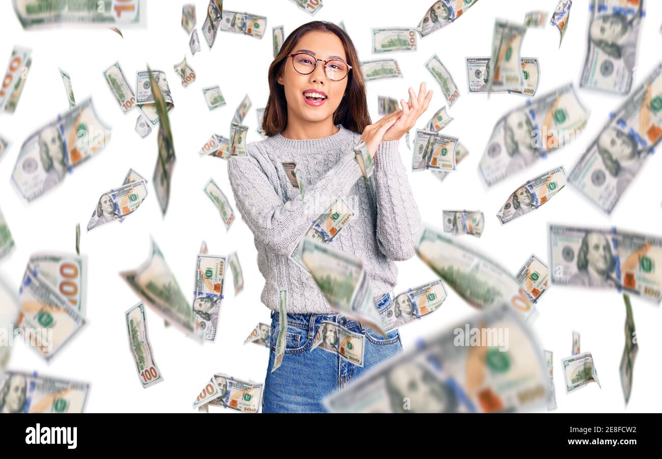 Young beautiful chinese girl wearing casual clothes clapping and ...