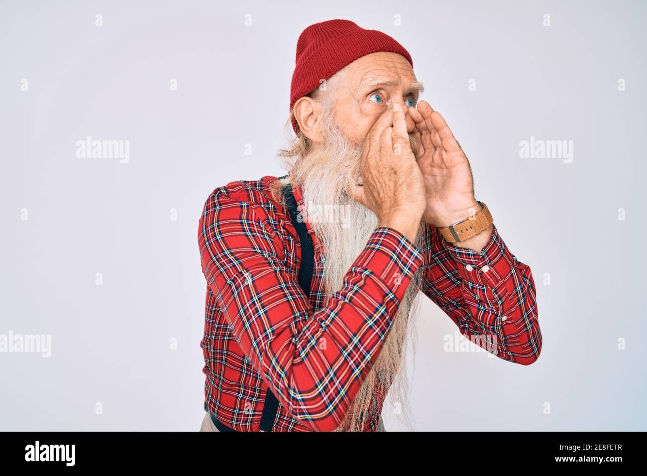 Old senior man with grey hair and long beard wearing hipster look with ...
