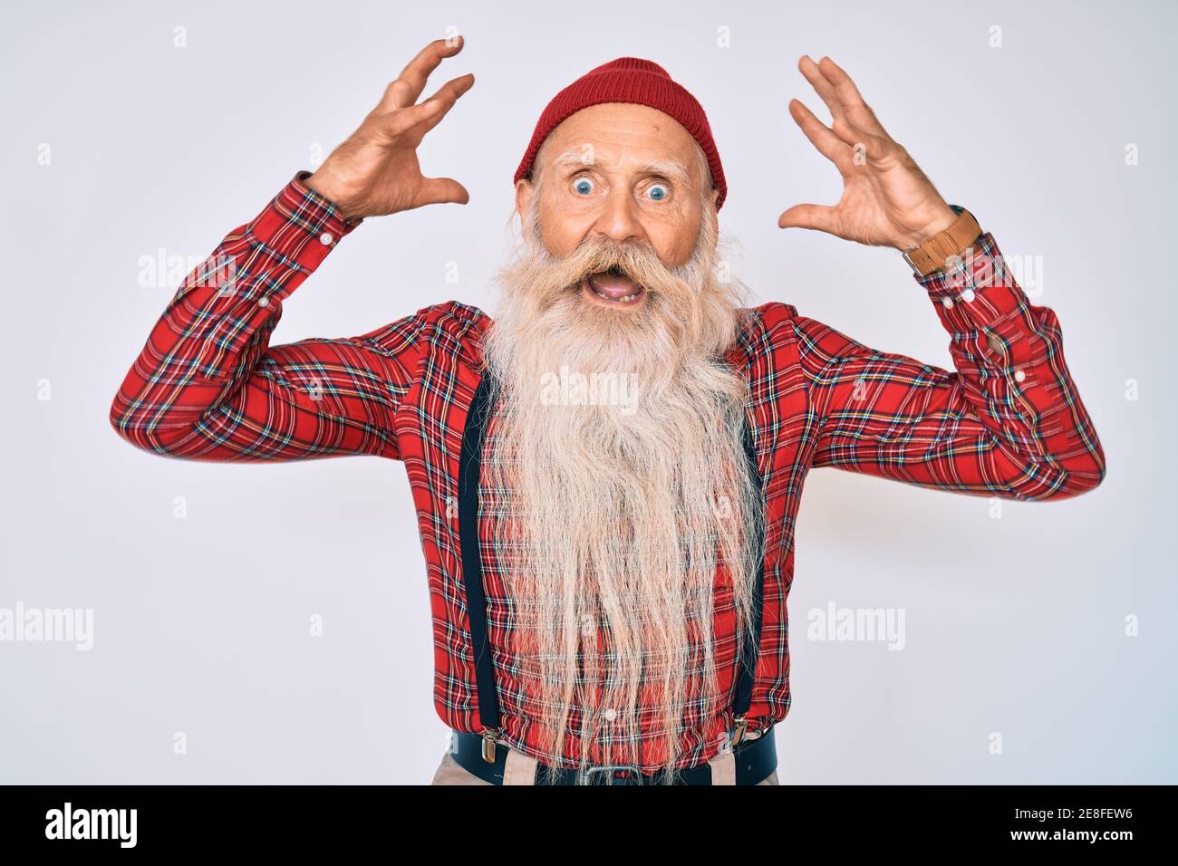 Old senior man with grey hair and long beard wearing hipster look with ...