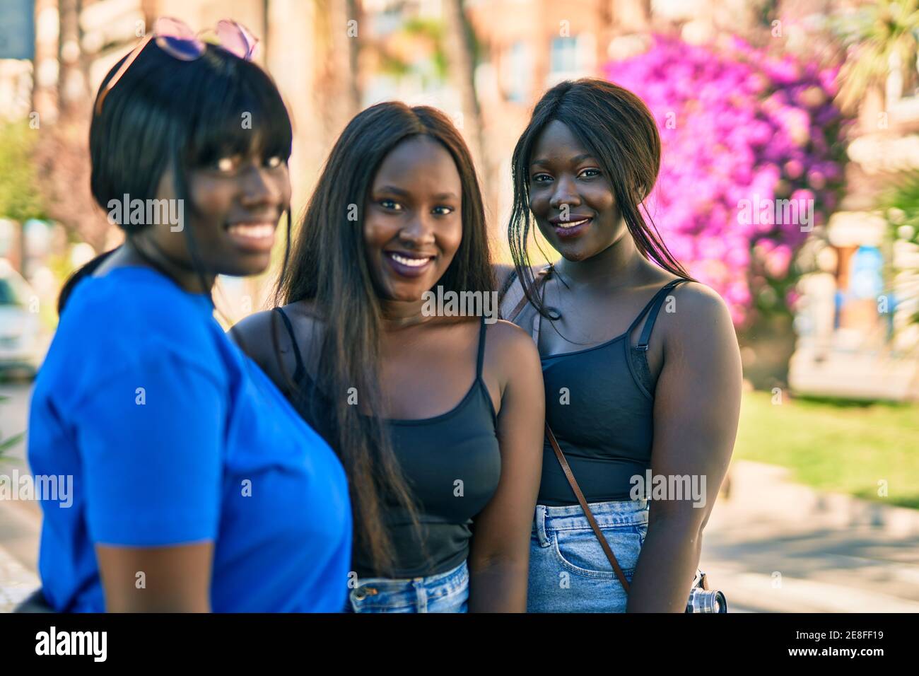Three african american friends smiling happy hugging at the city Stock ...