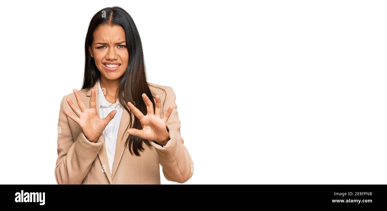 Beautiful hispanic woman wearing business jacket disgusted expression ...