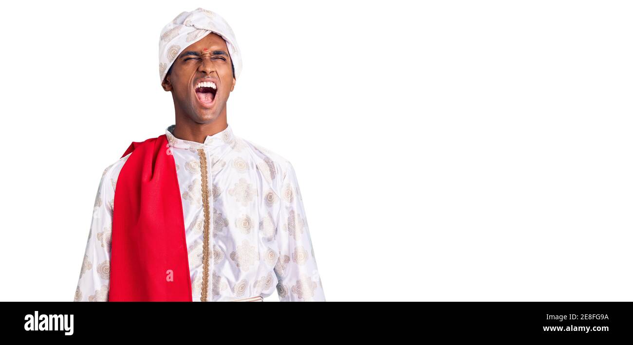 African handsome man wearing tradition sherwani saree clothes angry and ...