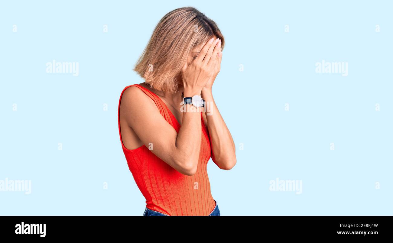 Beautiful caucasian woman wearing casual clothes with sad expression ...