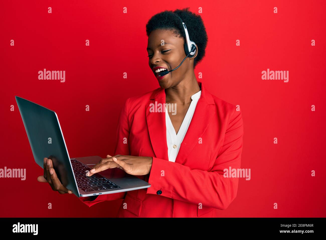 Young african american girl working at the office wearing operator ...