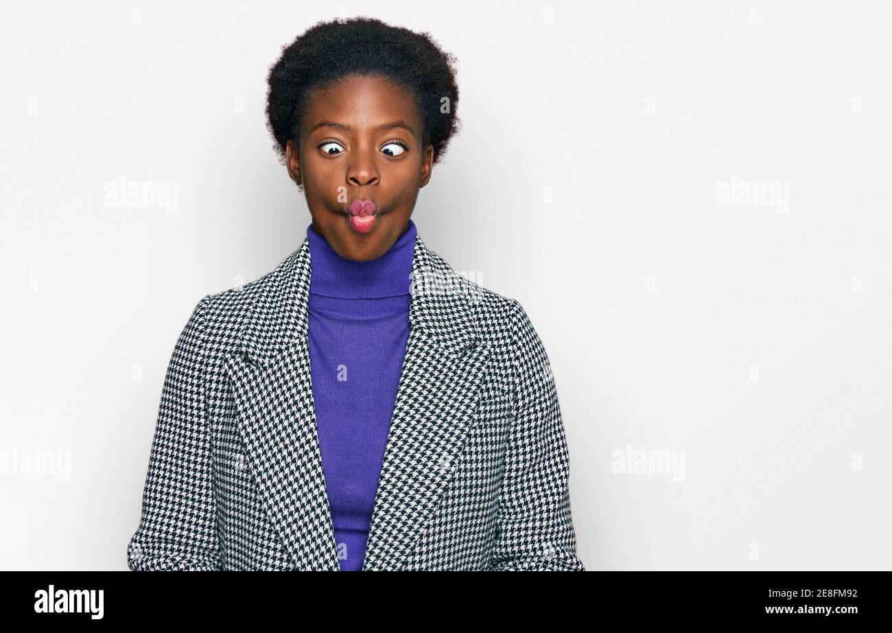 Young african american girl wearing casual clothes making fish face ...