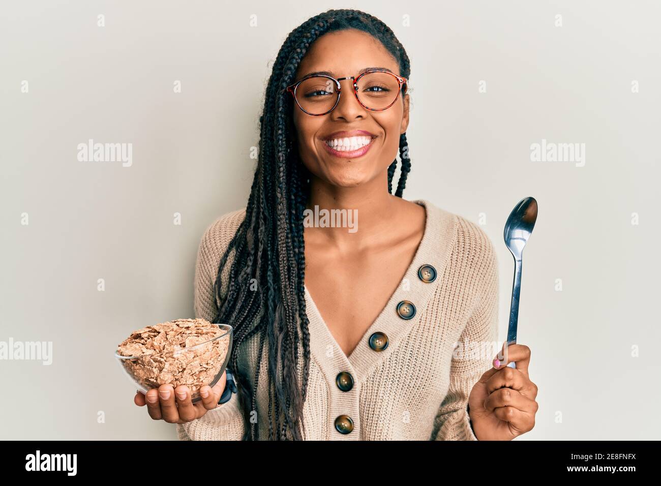 African american woman with braids eating healthy whole grain cereals ...