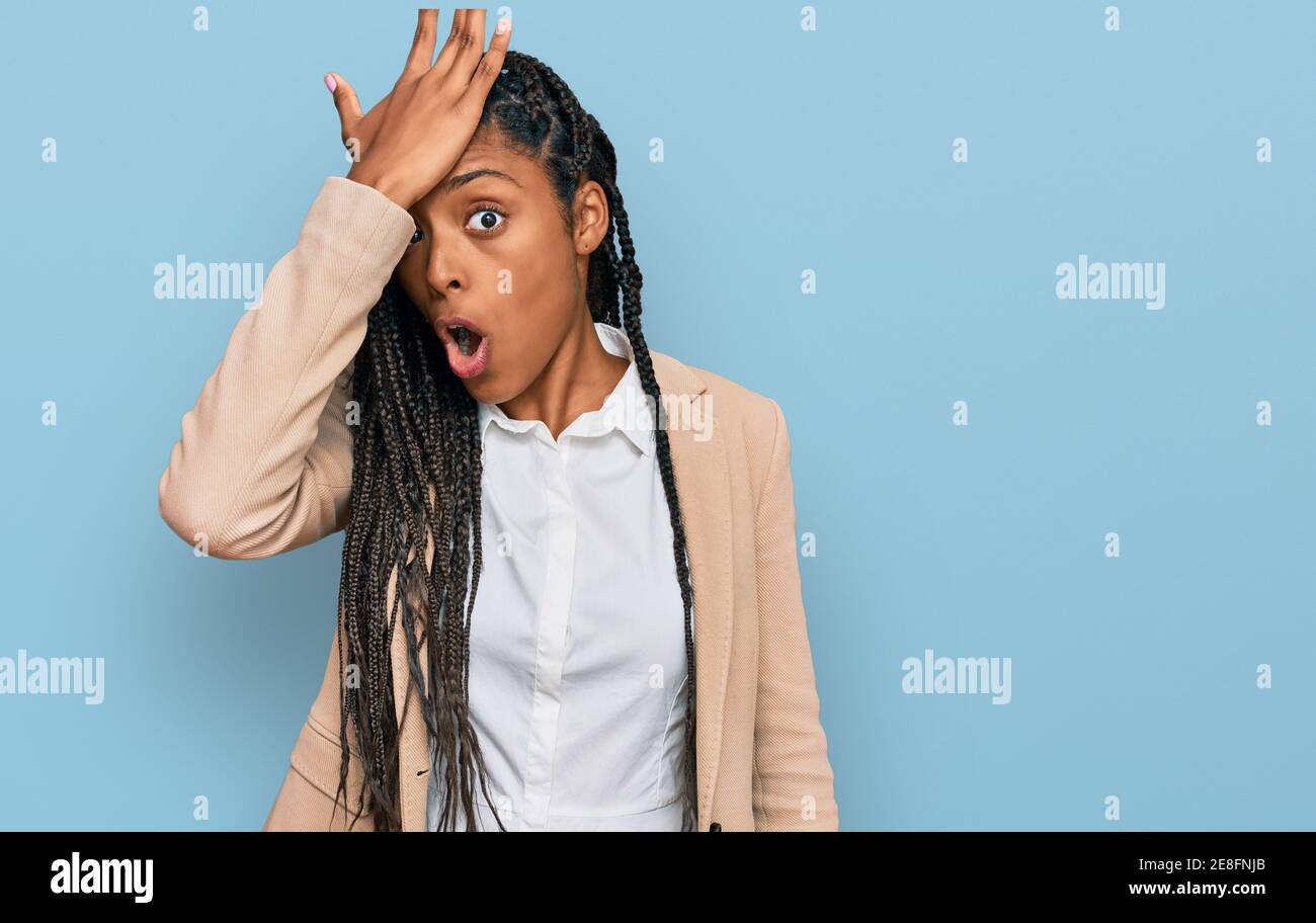 African american woman wearing business jacket surprised with hand on ...