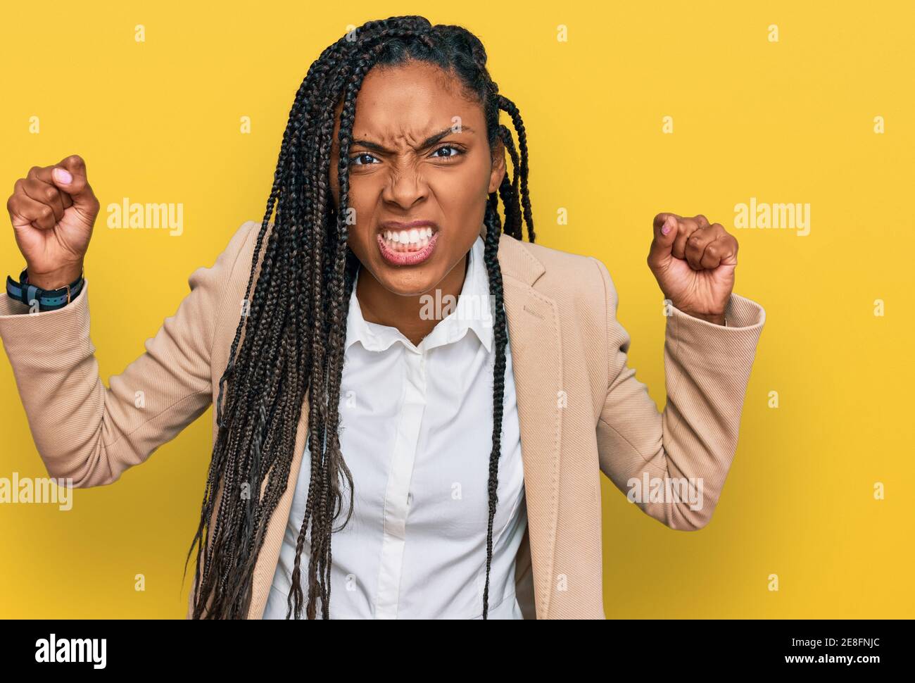 African american woman wearing business jacket angry and mad raising ...