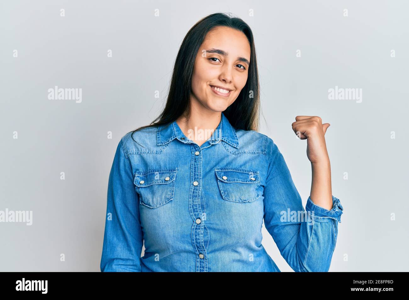 Young hispanic woman wearing casual denim jacket smiling with happy ...