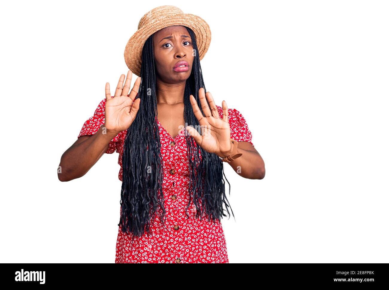 Young african american woman wearing summer hat moving away hands palms ...