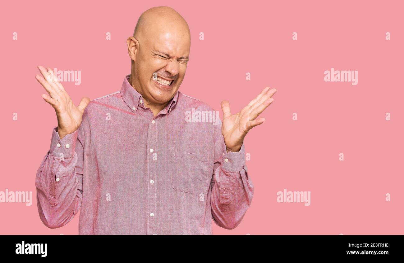 Middle age bald man wearing casual clothes celebrating mad and crazy ...