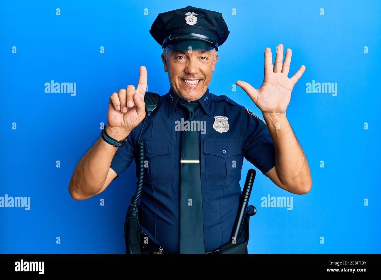 Handsome middle age mature man wearing police uniform showing and ...