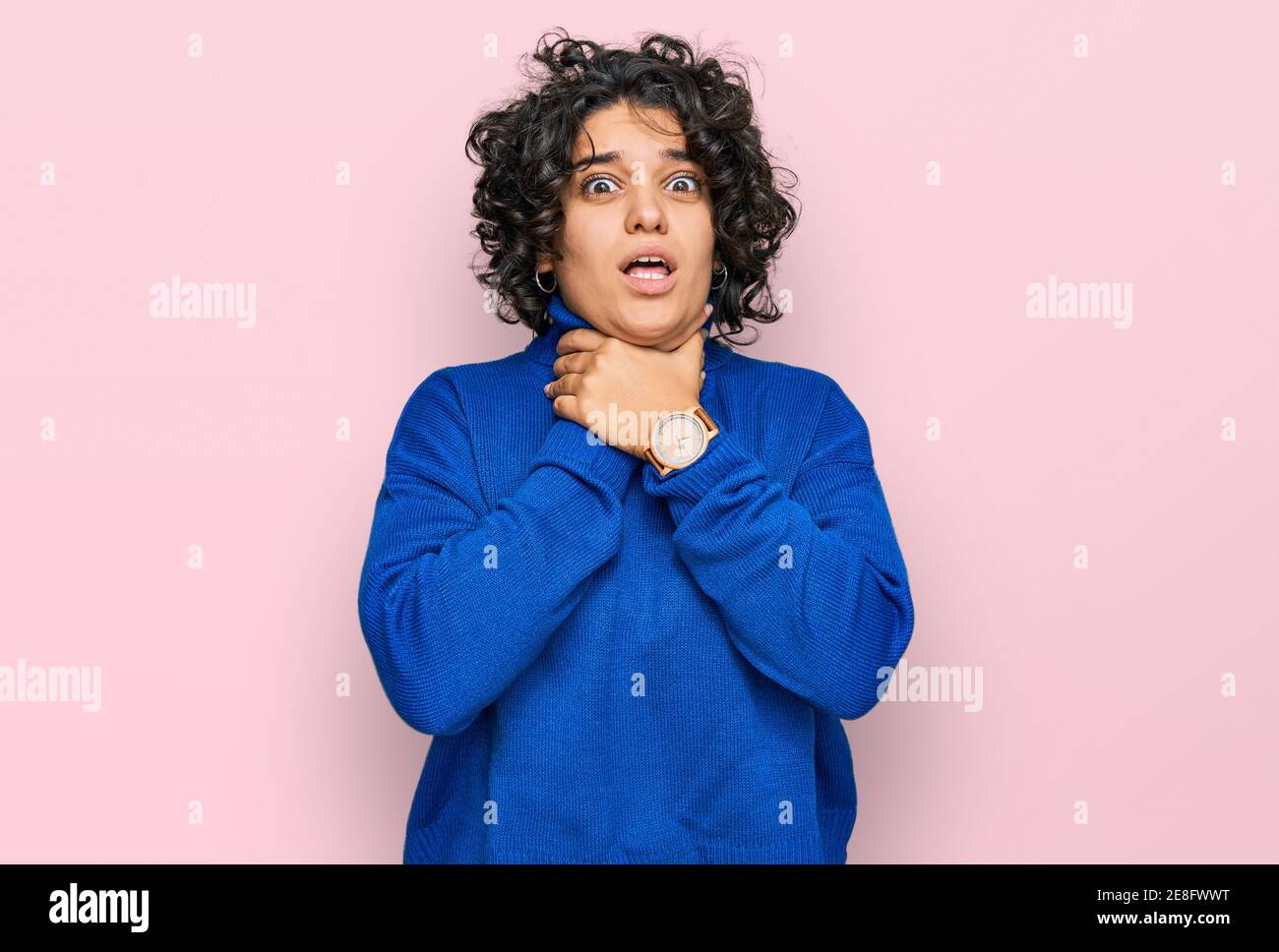 Young hispanic woman with curly hair wearing turtleneck sweater ...