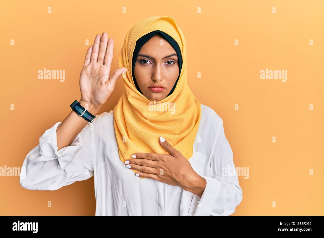 Young brunette arab woman wearing traditional islamic hijab scarf ...