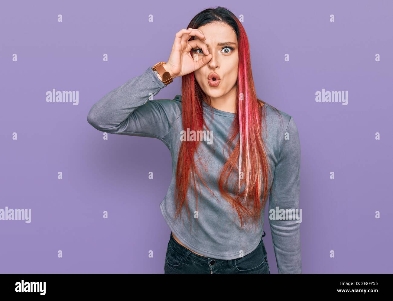 Young caucasian woman wearing casual clothes doing ok gesture shocked ...