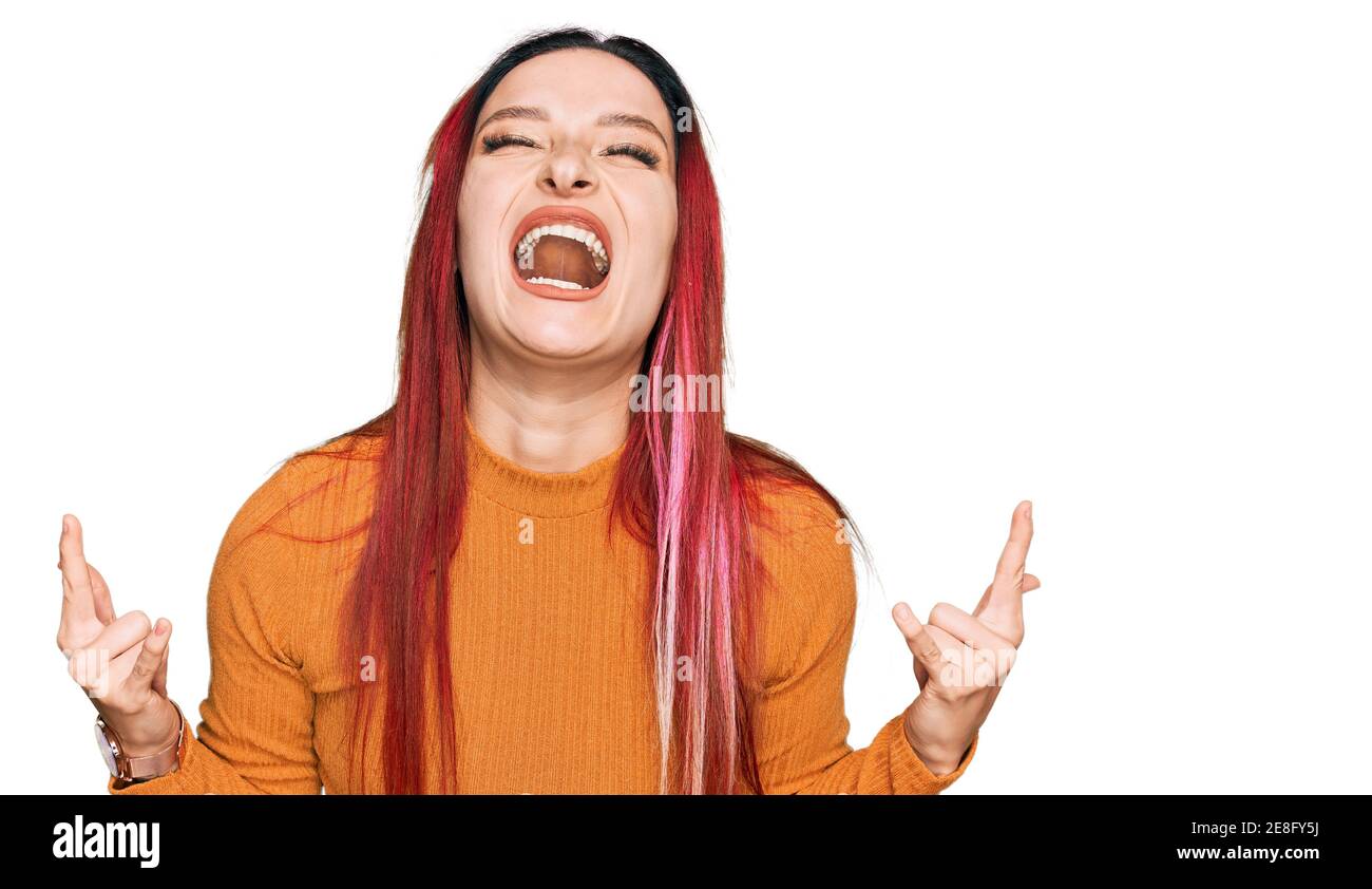 Young caucasian woman wearing casual clothes shouting with crazy ...