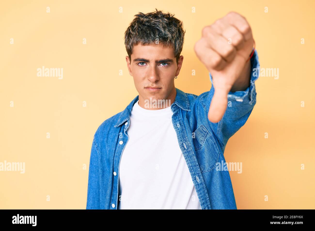 Young handsome man wearing casual clothes looking unhappy and angry ...