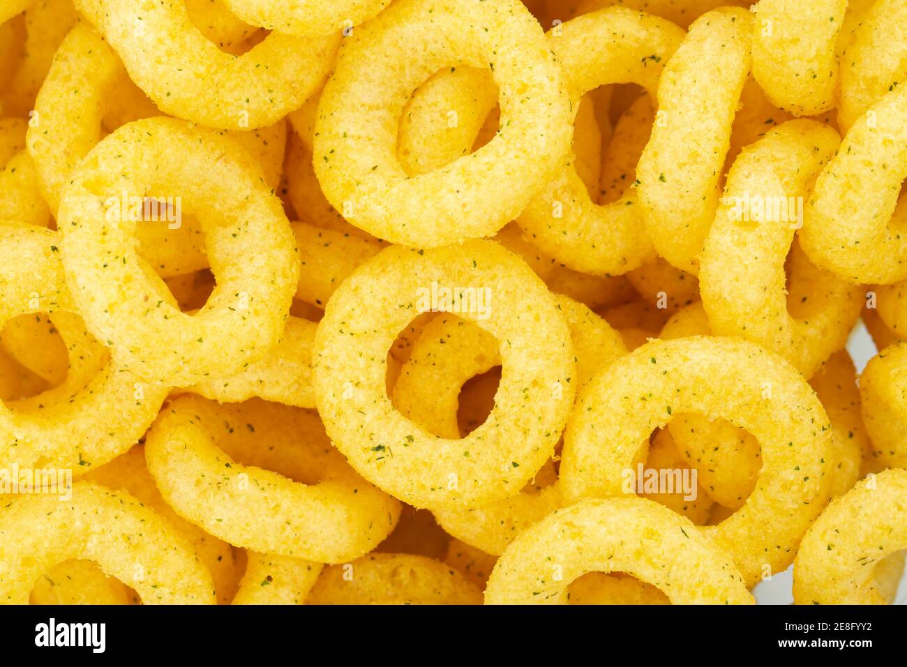 Beer snacks. Background of corn rings of sticks with cheese and green ...
