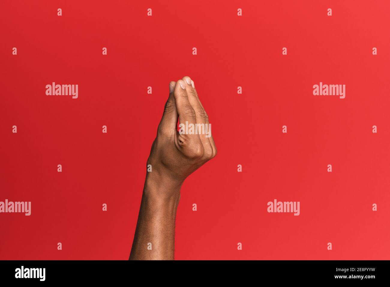 Hand of hispanic man over red isolated background doing italian gesture ...