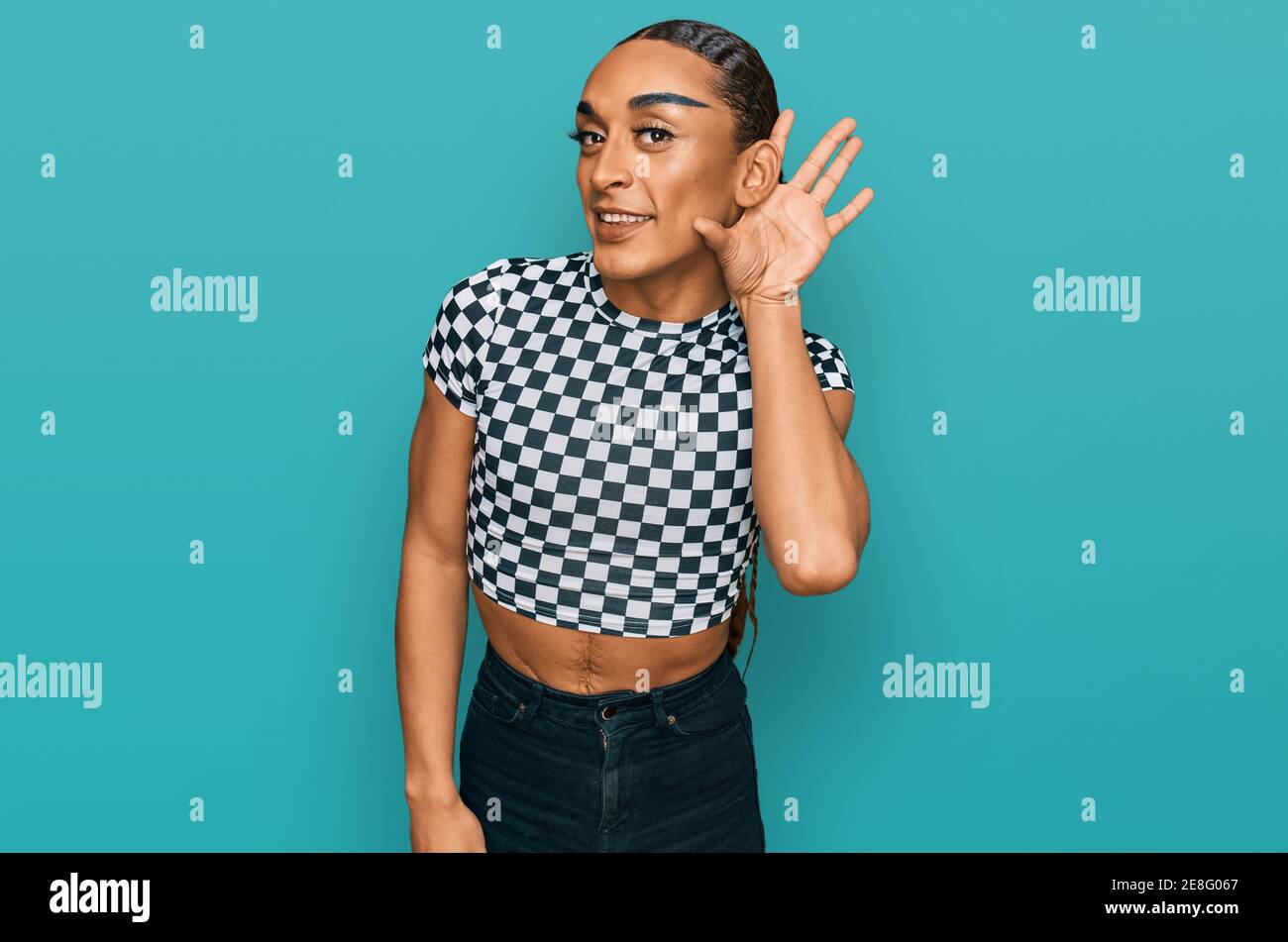Hispanic transgender man wearing make up and long hair wearing modern ...