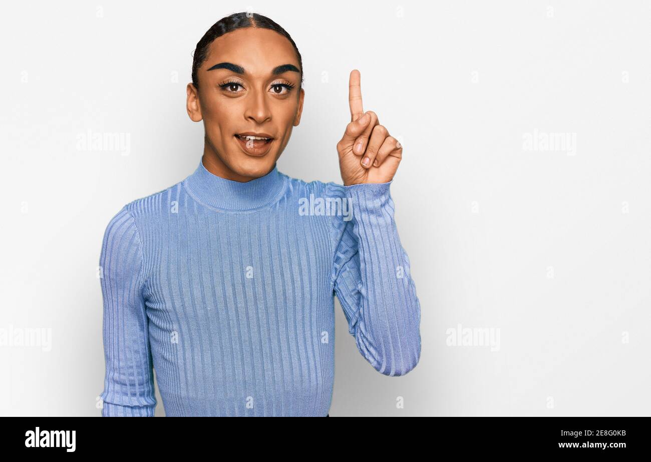 Hispanic transgender man wearing make up and long hair wearing casual ...