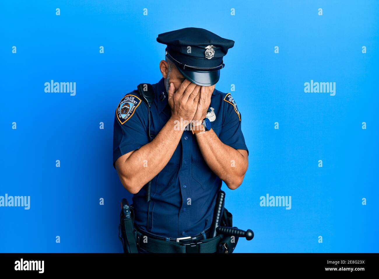 Middle age handsome man wearing police uniform with sad expression ...