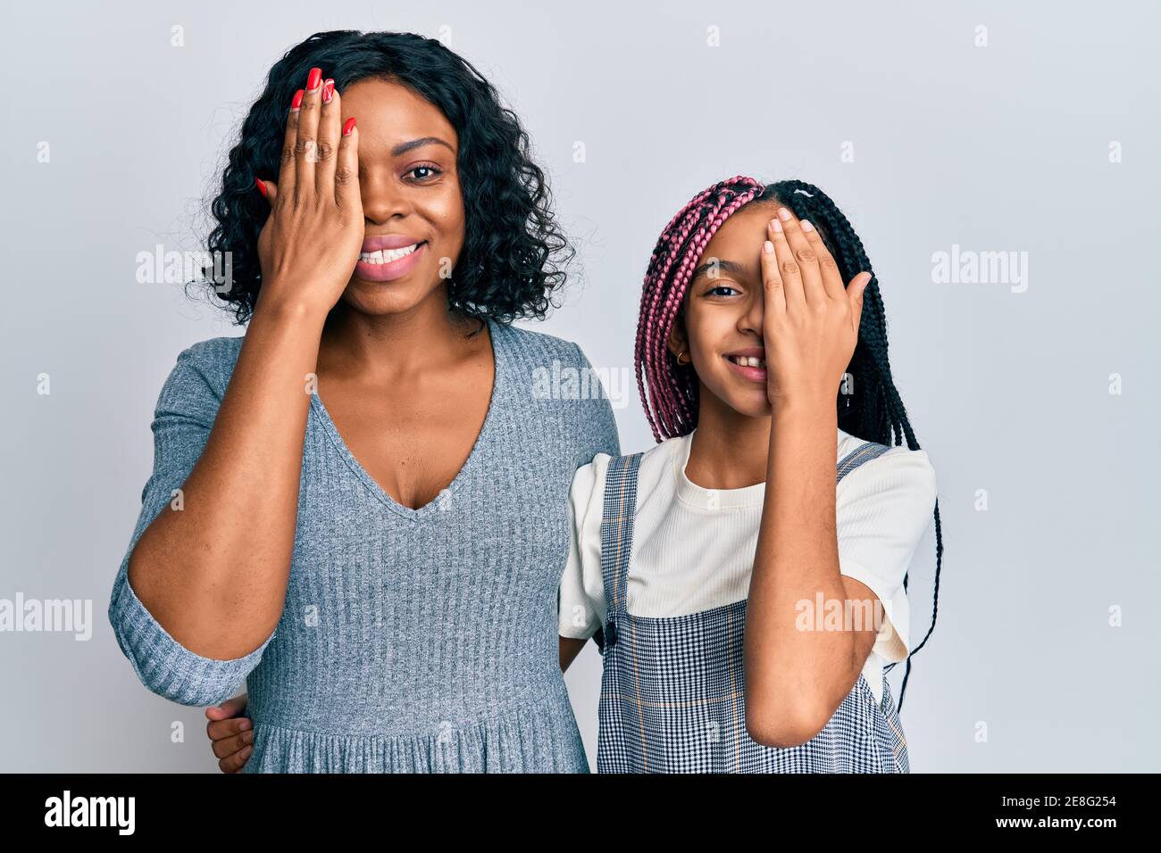 Beautiful african american mother and daughter wearing casual clothes ...