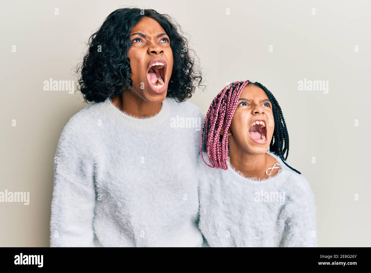 Beautiful african american mother and daughter wearing casual winter ...