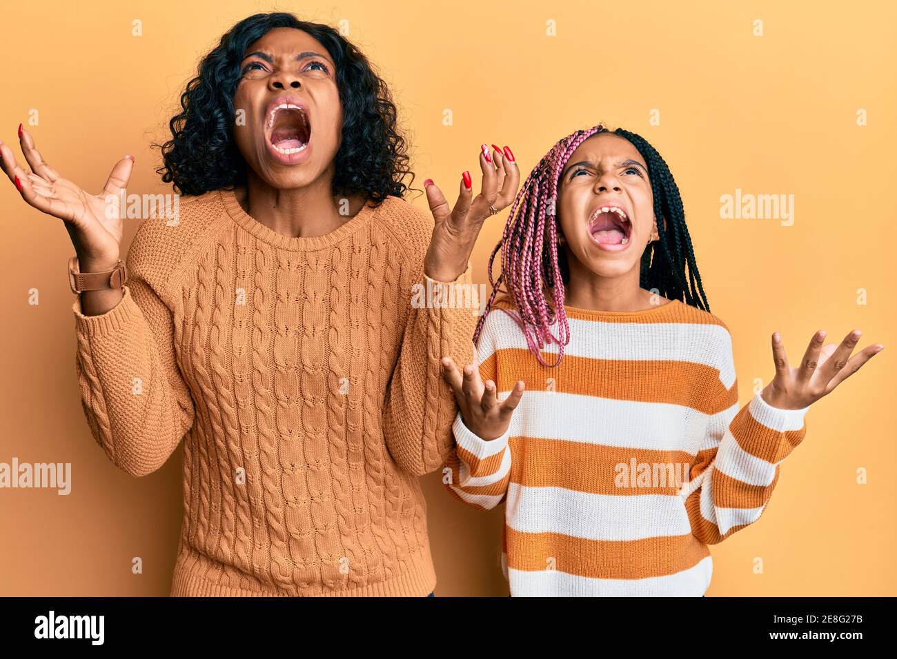 Beautiful african american mother and daughter wearing wool winter ...
