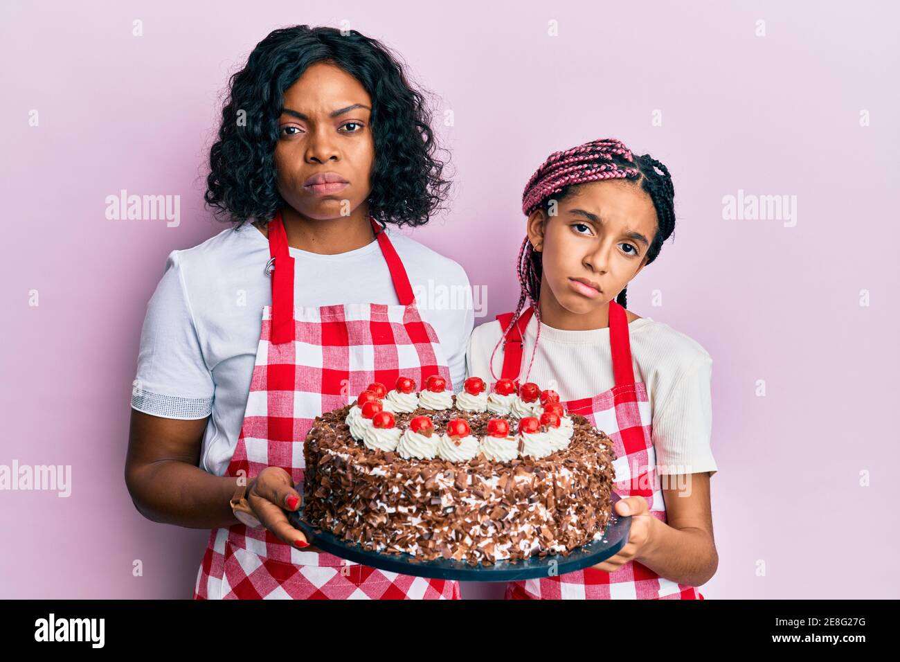 Beautiful african american mother and daughter wearing baker apron ...