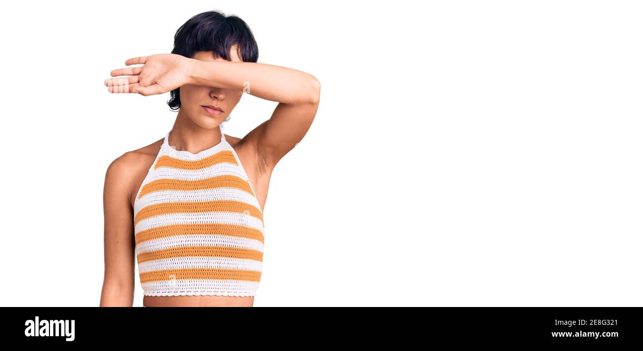 Young brunette woman with short hair wearing casual clothes covering ...