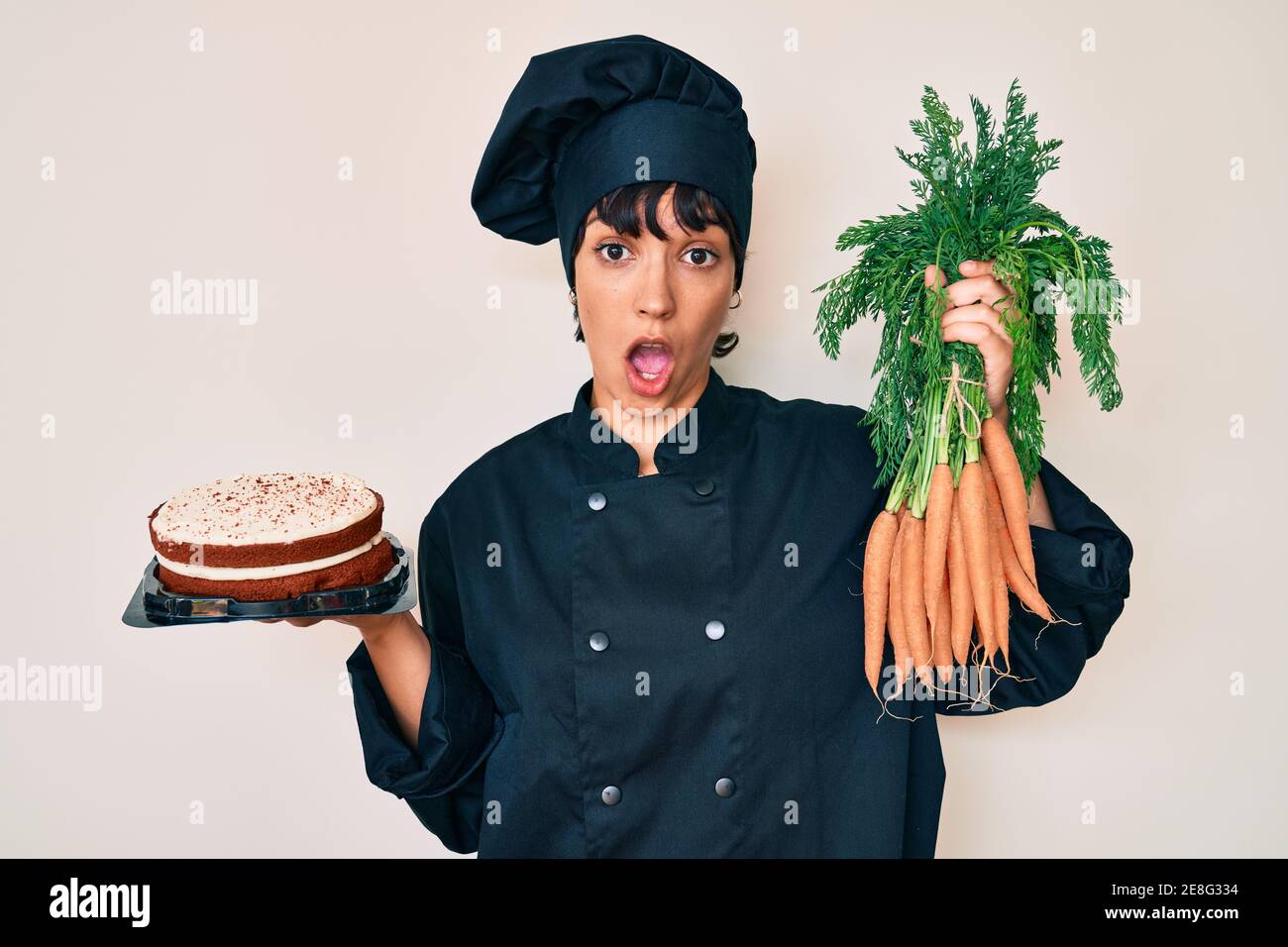 Beautiful brunettte woman chef cooking carrot cake in shock face ...