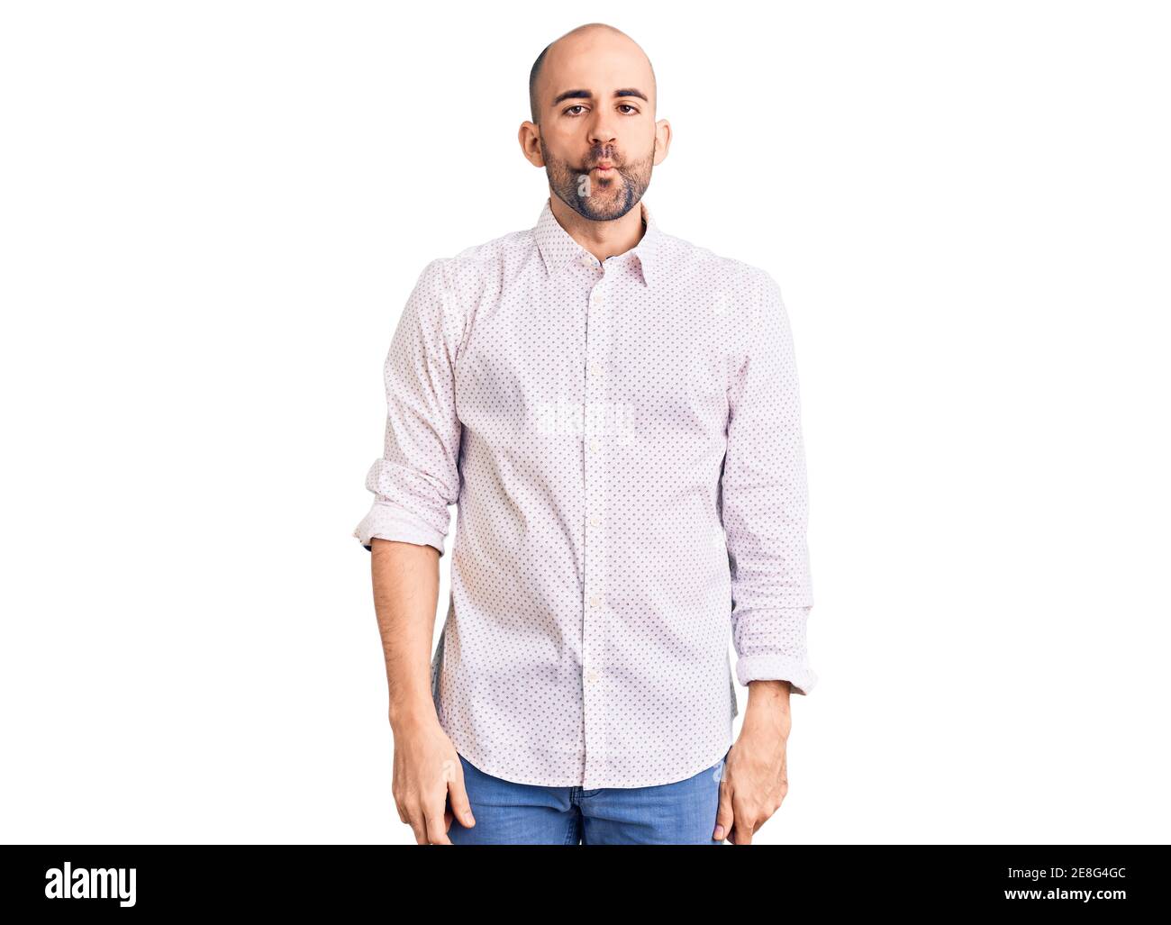Young handsome man wearing elegant shirt making fish face with lips ...