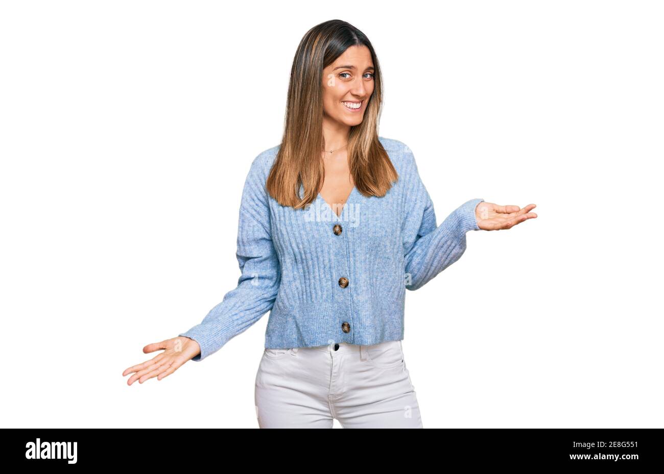 Young woman wearing casual clothes smiling cheerful with open arms as ...