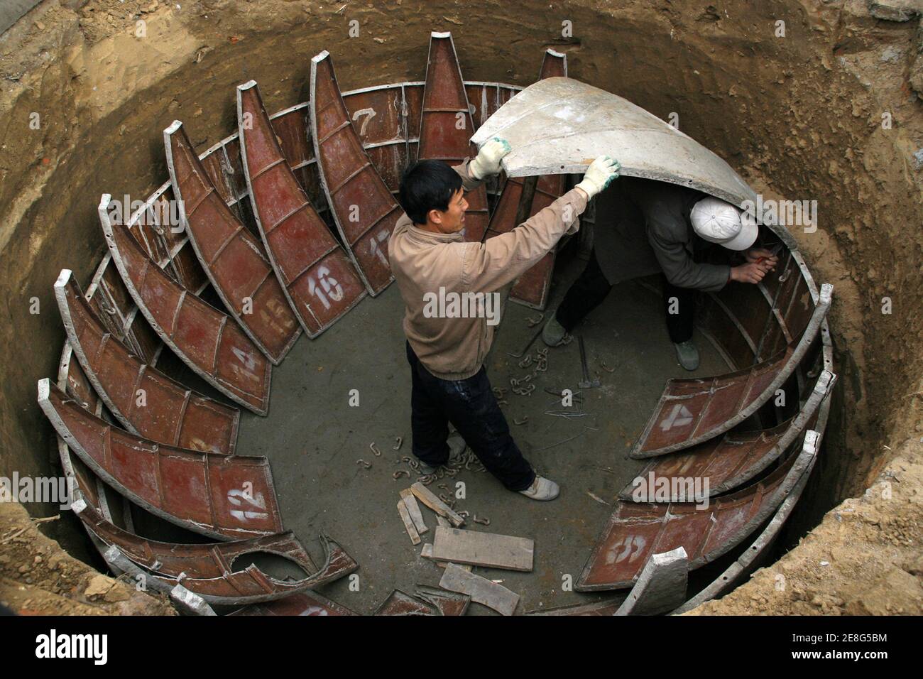 workers building digester in china Stock Photo - Alamy