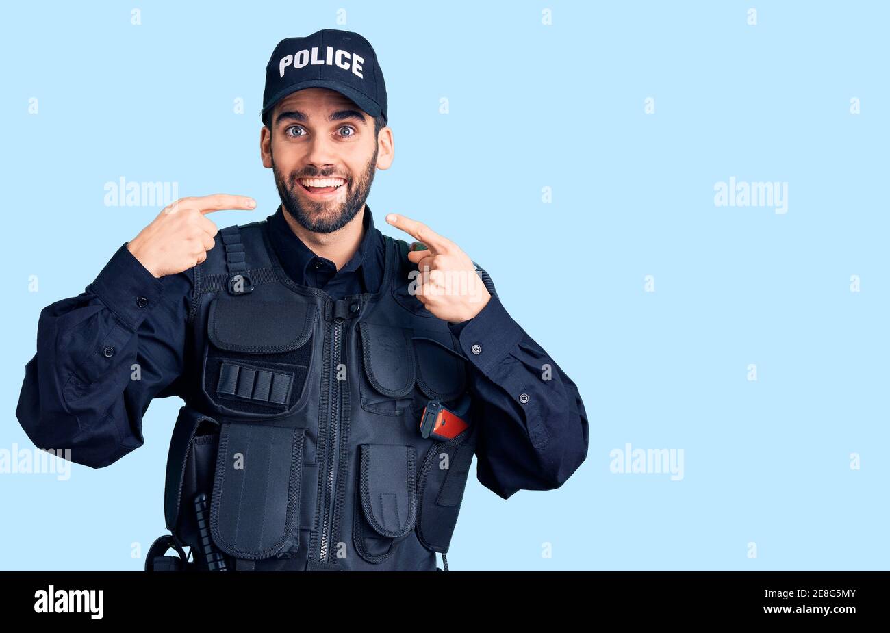 Young handsome man with beard wearing police uniform smiling cheerful ...