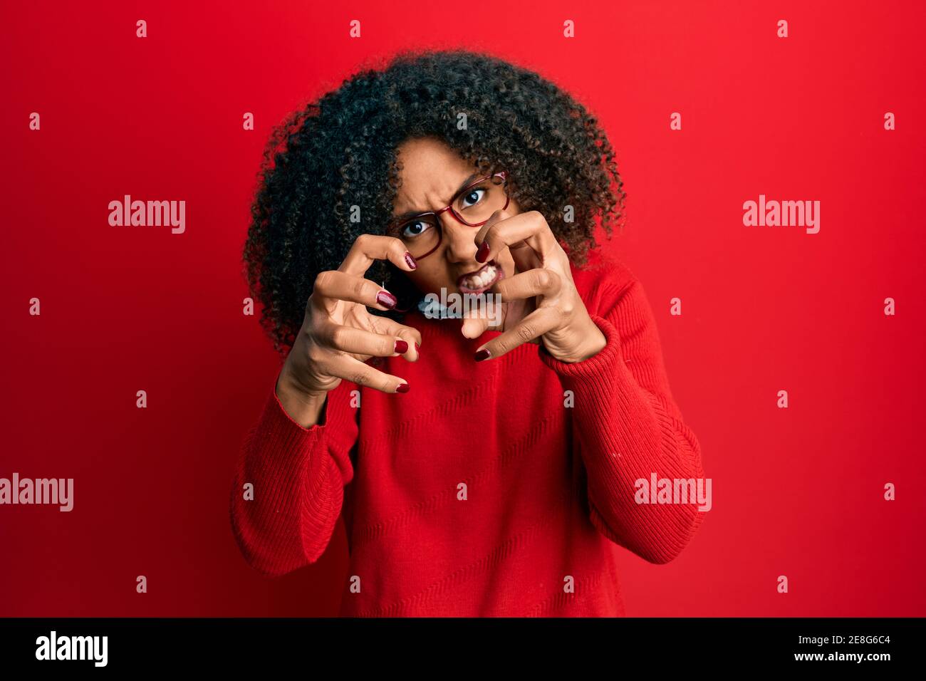Beautiful african american woman with afro hair wearing sweater and ...