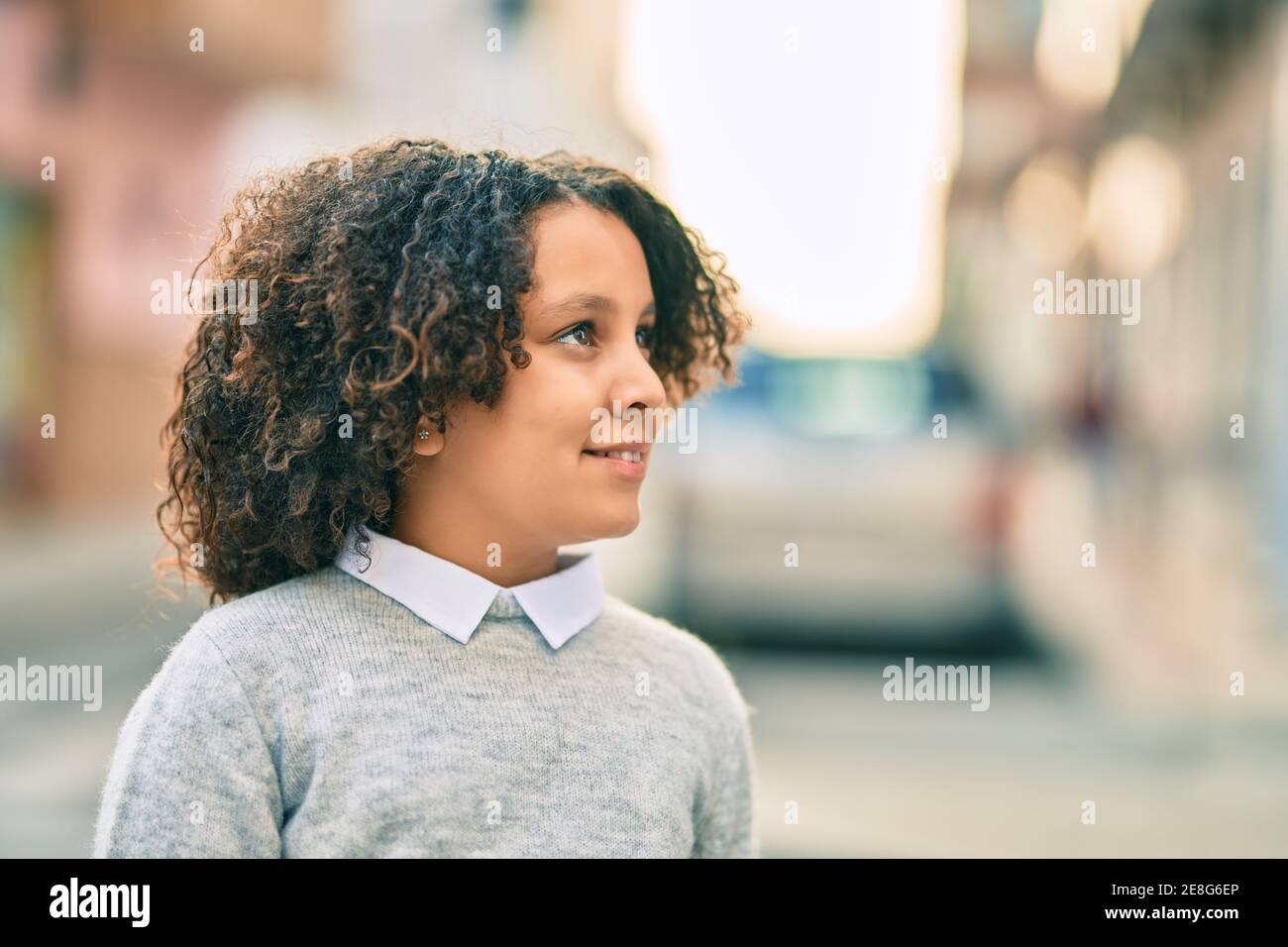 Adorable hispanic child girl smiling happy standing at the city Stock ...
