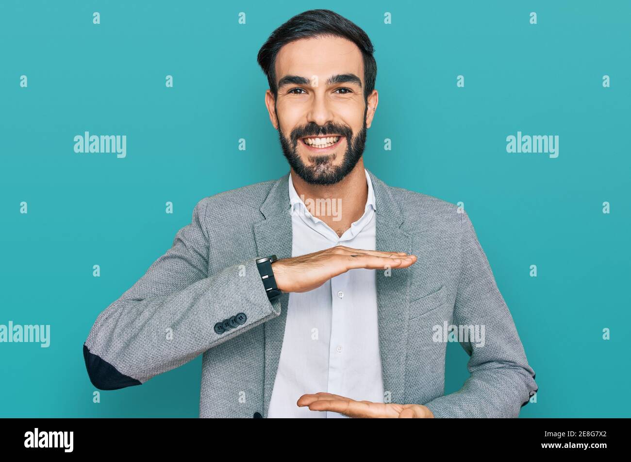 Young hispanic man wearing business clothes gesturing with hands ...